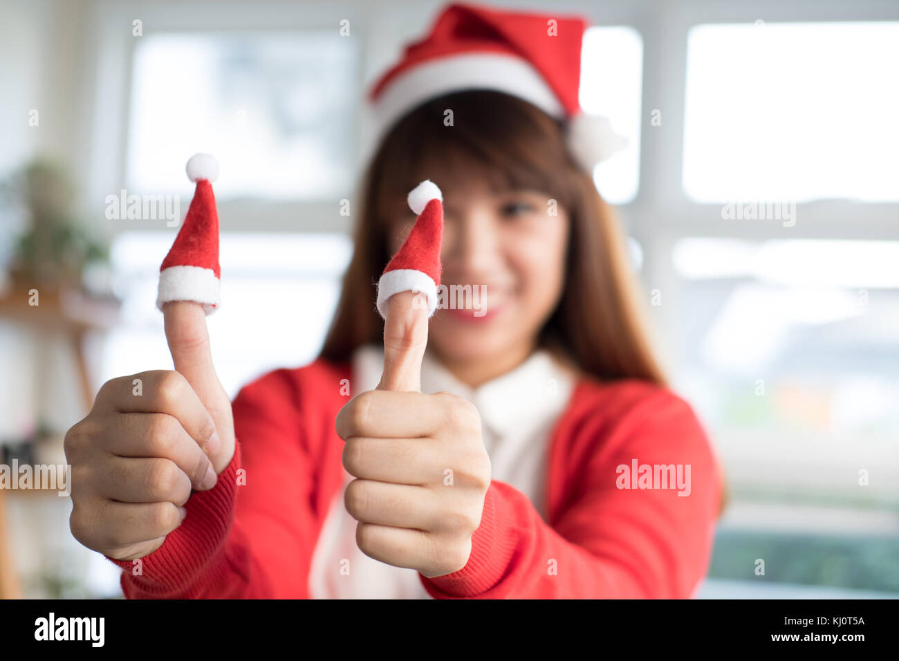 asian woman wear santa hat shows thumb up. asian female wear white ...