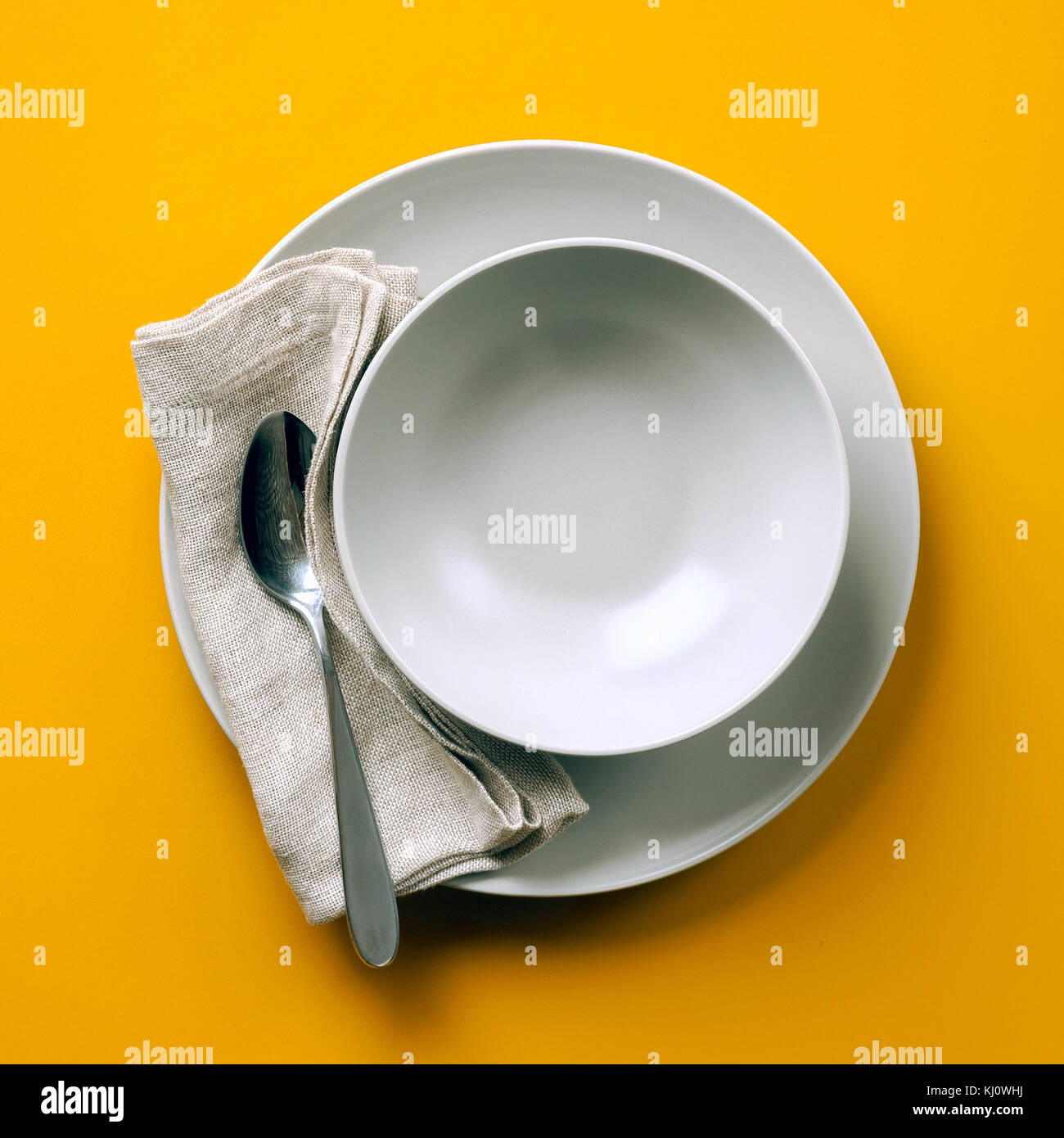 empty plate for soup on a yellow background Stock Photo - Alamy