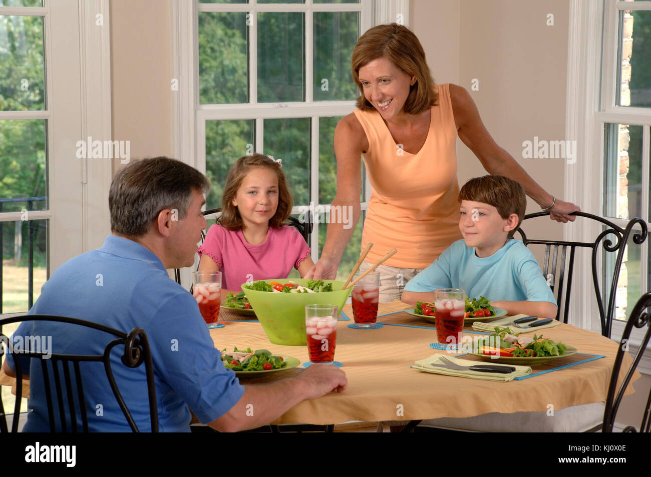 Family gathered around table outdoors hi-res stock photography and ...