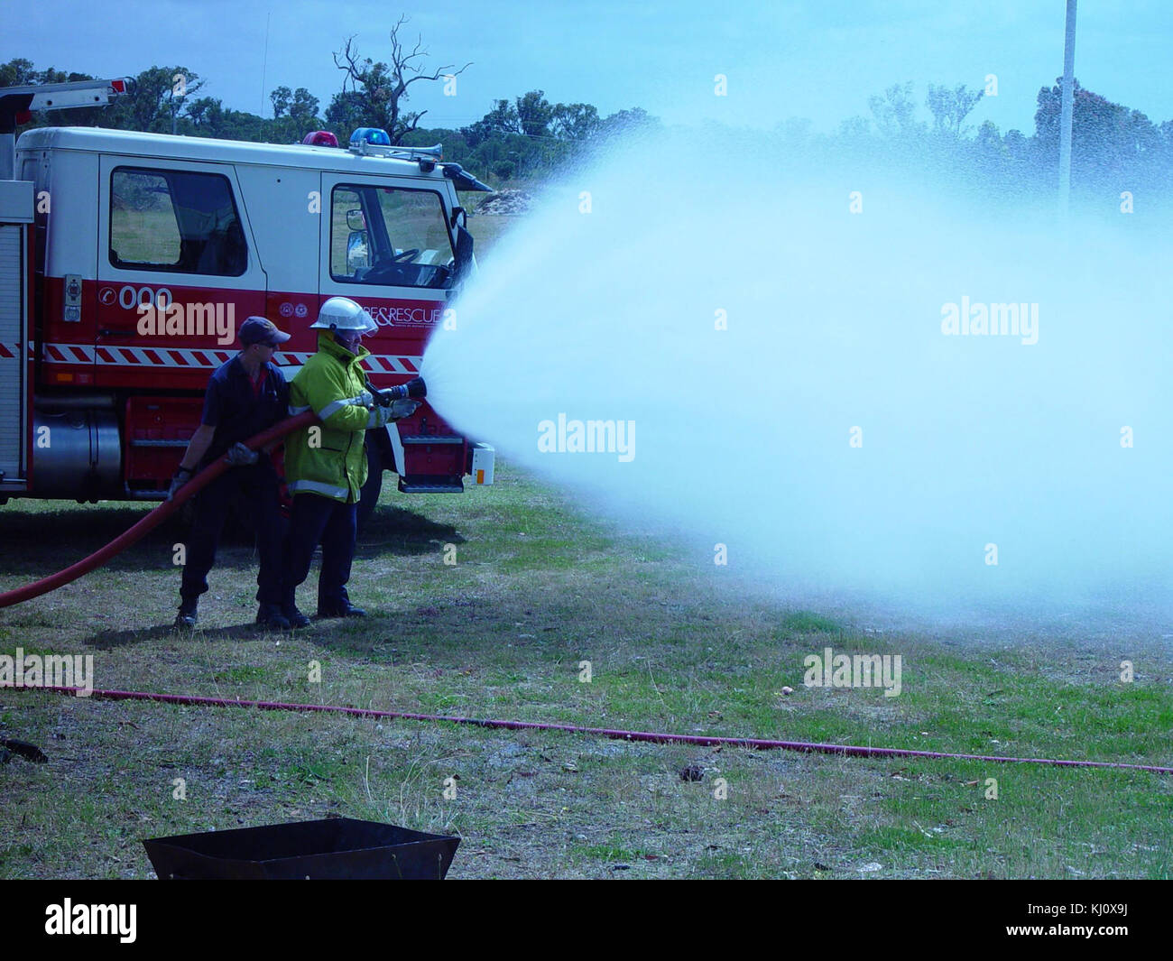 Fire hose on maximum spray Stock Photo - Alamy