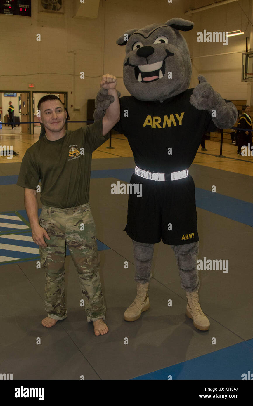 Sgt. Rocky, 3rd Infantry Division's mascot, holds up the arm of the fly ...