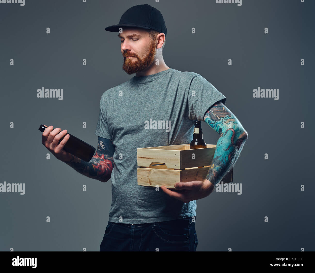 A man holds a wooden box with beer bottles Stock Photo - Alamy