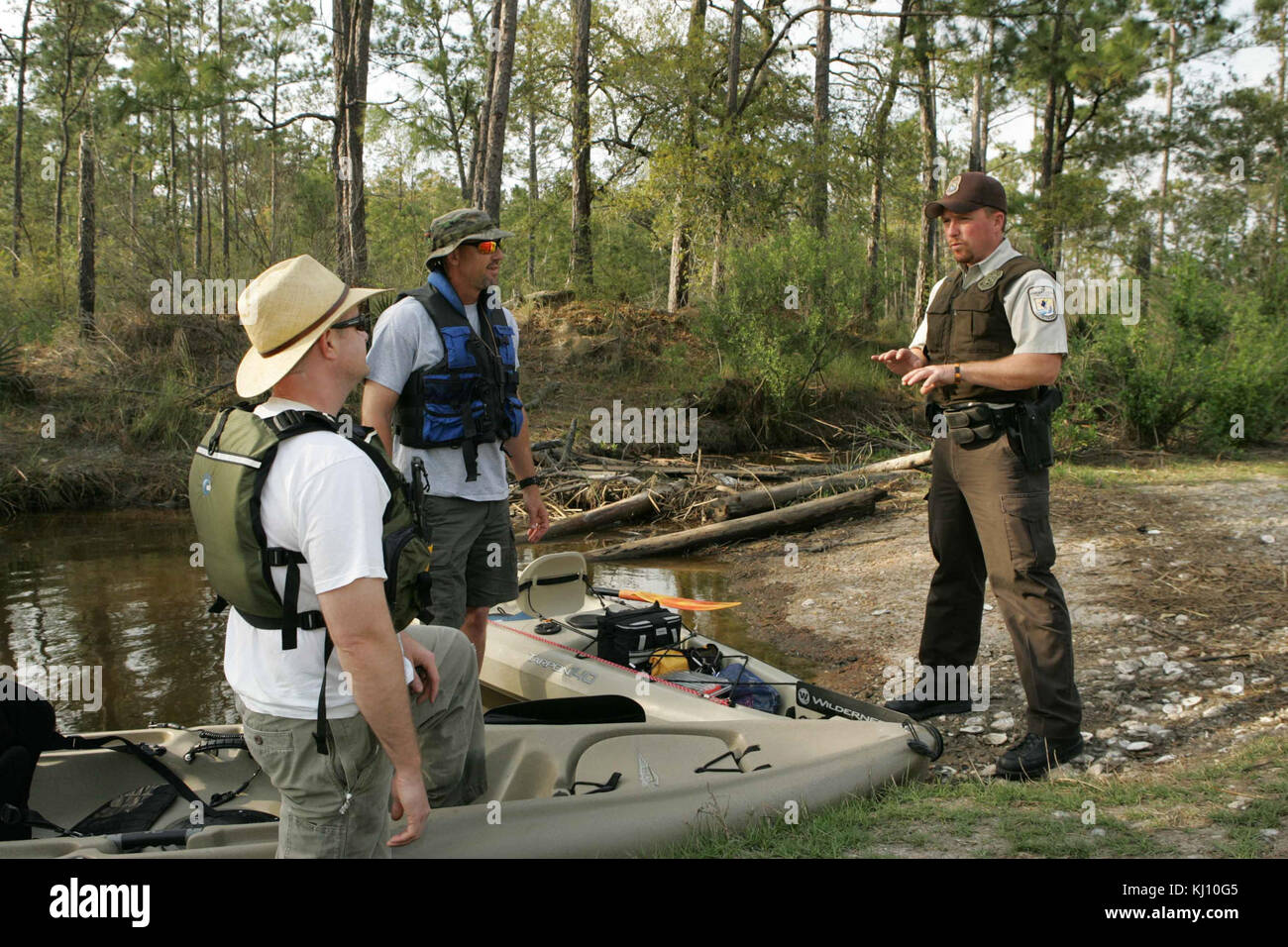 Law enforcement officer with two men Stock Photo - Alamy