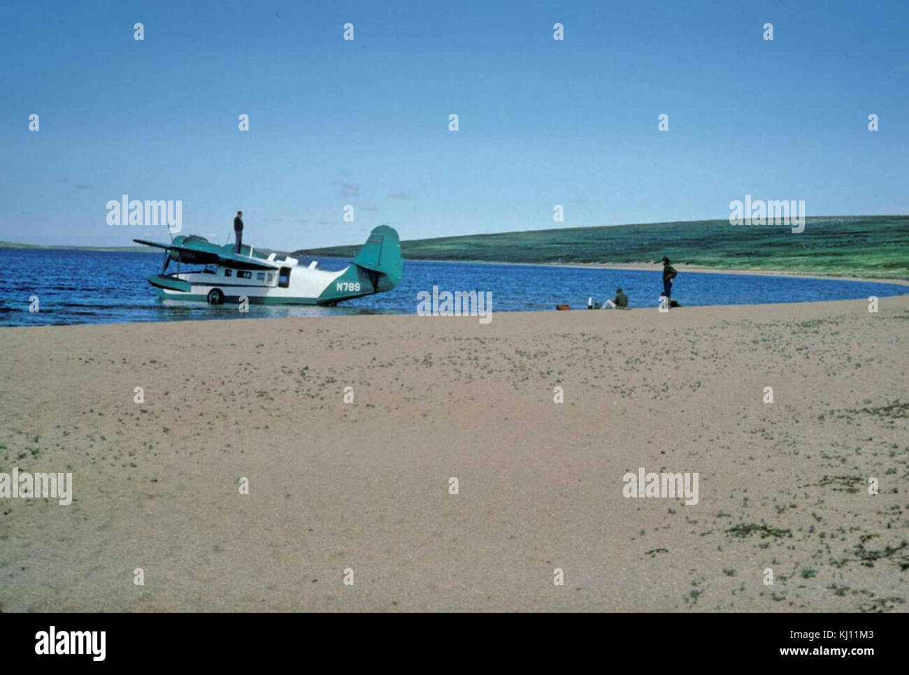 Loading off from float plane to coast Stock Photo - Alamy