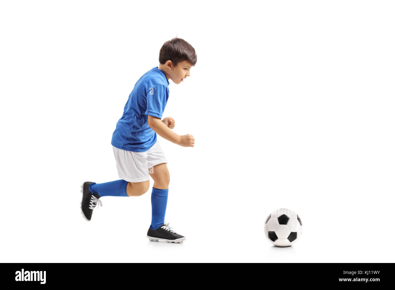 Full length profile shot of a little footballer running towards a ...