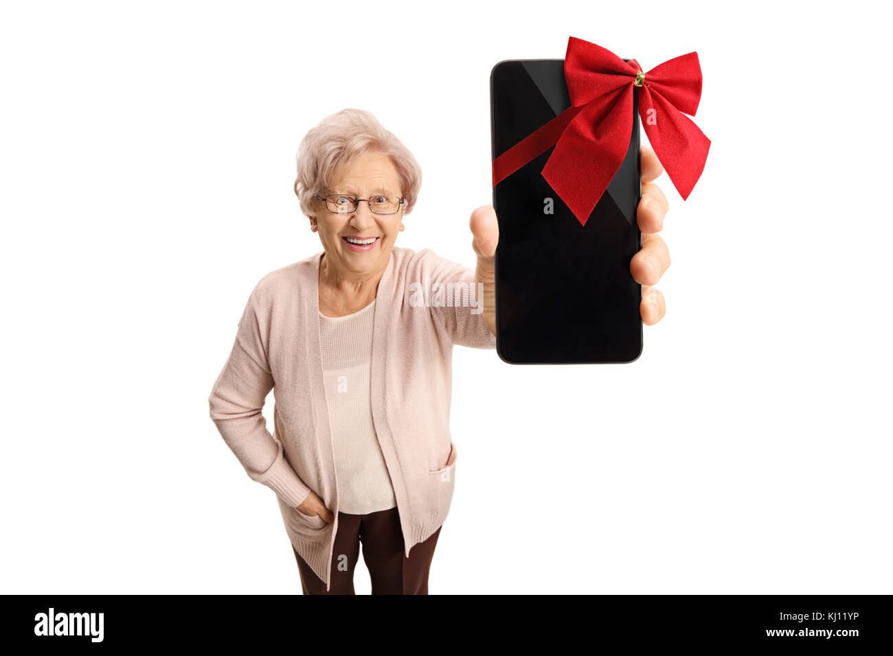 Joyful elderly woman showing a phone wrapped with red ribbon as a gift ...