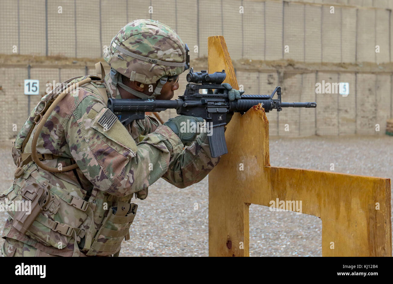 A Soldier fires his M4 rifle in a marksmanship competition as part of ...