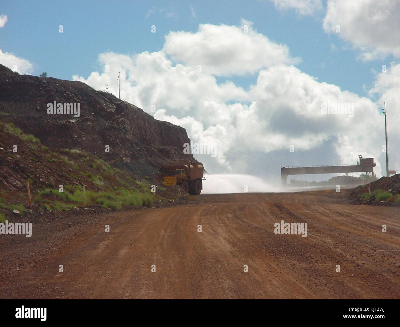 Primary crusher and water truck paraburdoo mine Stock Photo - Alamy