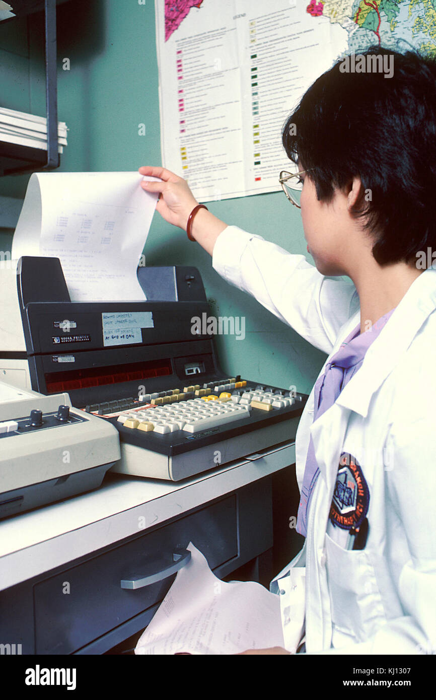 Reading a computer printout Stock Photo - Alamy