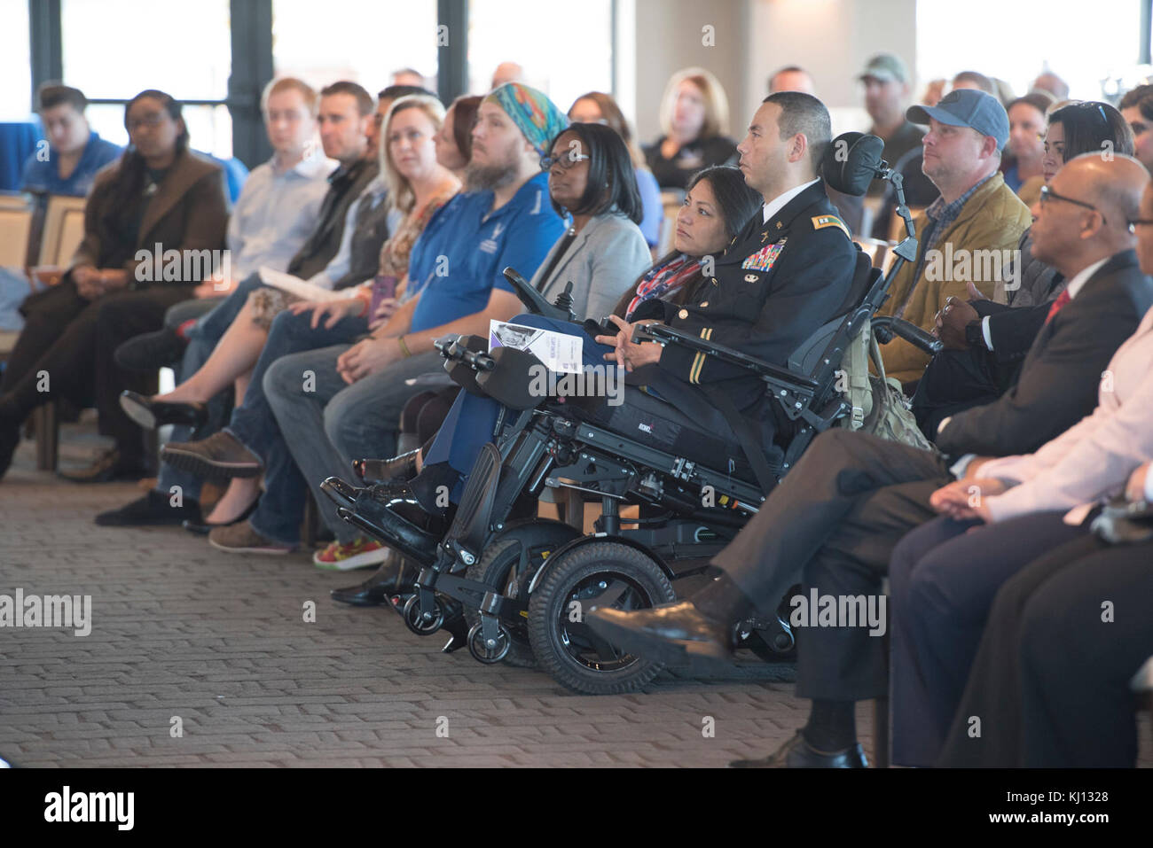 Army Capt. Luis Avila, center, and his wife and caregiver Claudia ...