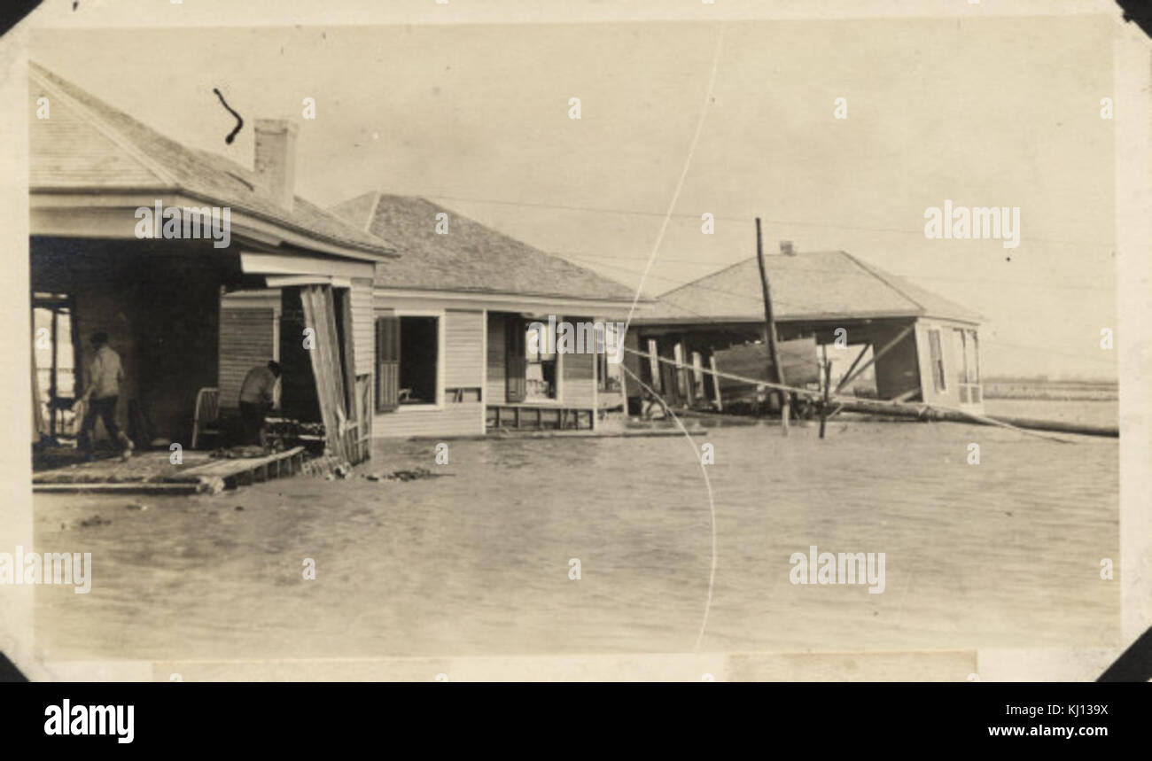 Salvaging from houses submerged in sand Stock Photo - Alamy