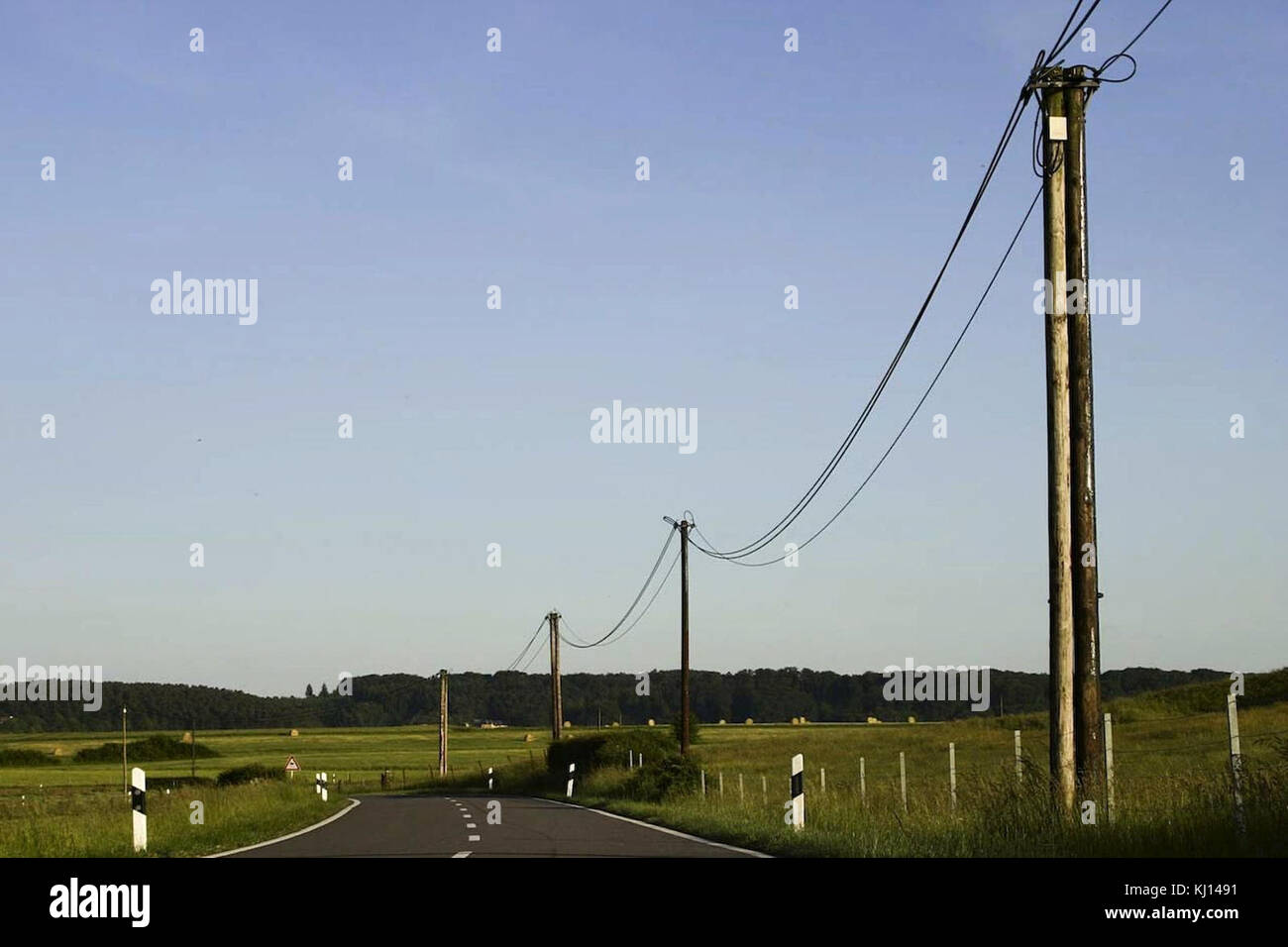 Telephone line by road Stock Photo - Alamy