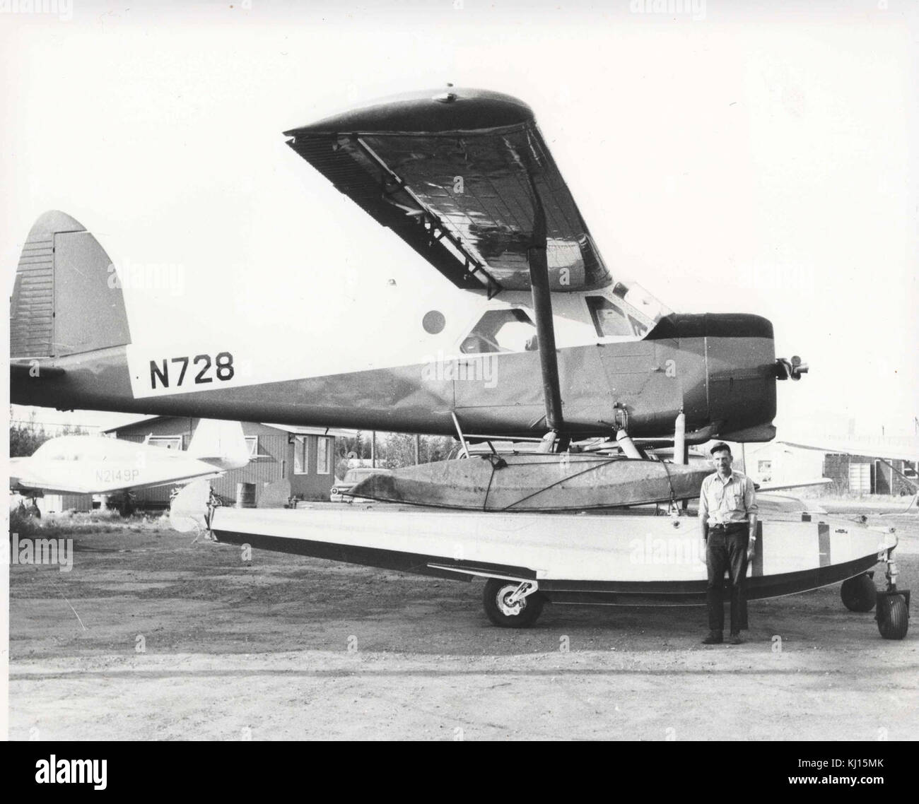 Man standing in front of float plane Stock Photo - Alamy