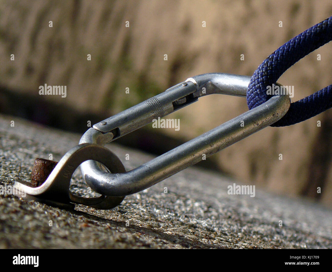 A carabiner, a metal loop with a spring-loaded gate used in climbing ...