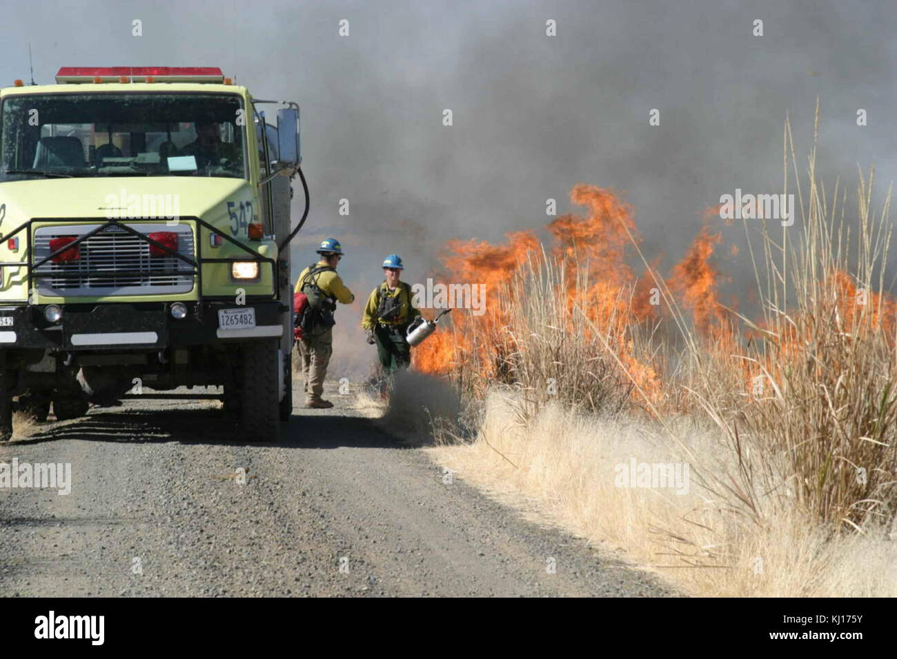 Marsh burning firemans setting fire Stock Photo - Alamy
