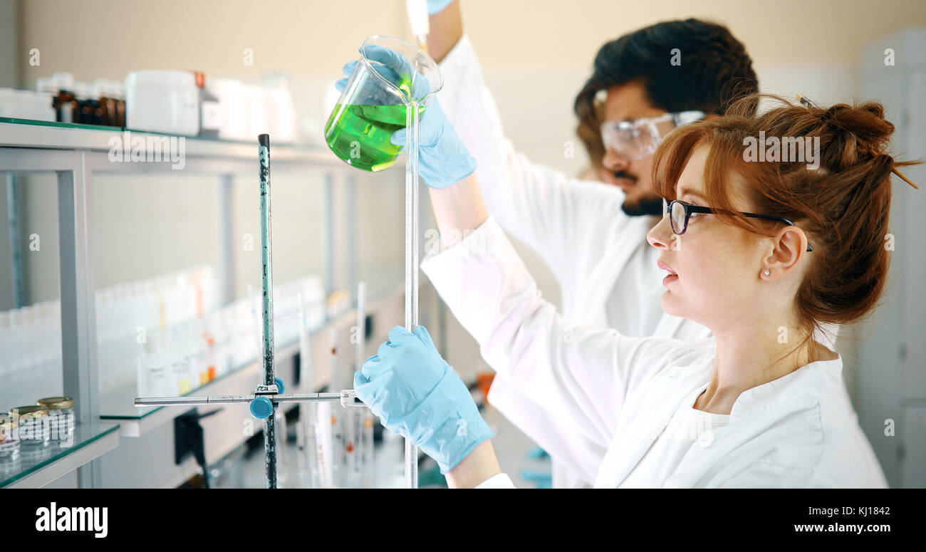 Group of chemistry students working in laboratory Stock Photo - Alamy