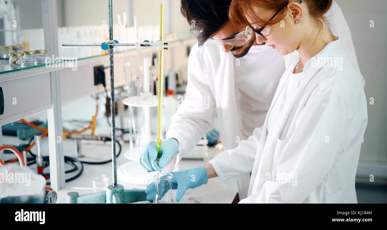 Young students of chemistry working in laboratory Stock Photo - Alamy