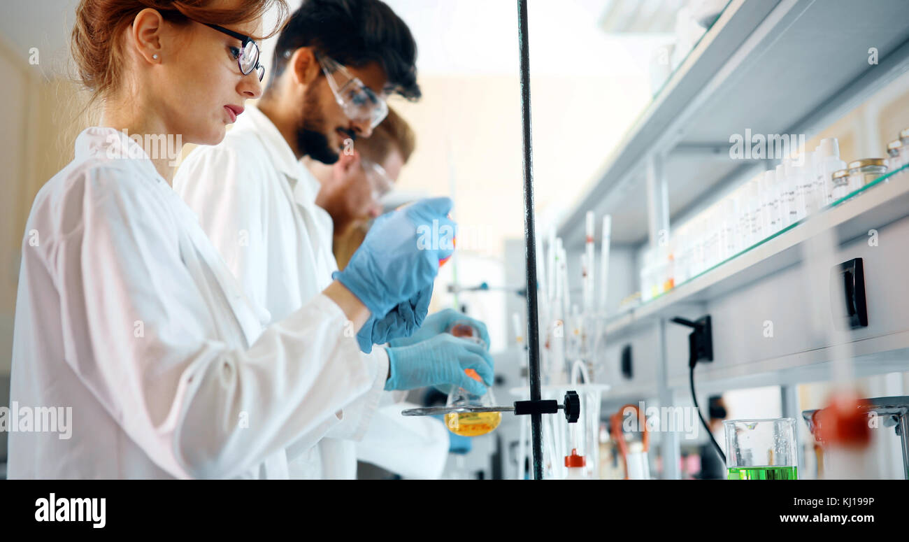 Group of chemistry students working in laboratory Stock Photo - Alamy