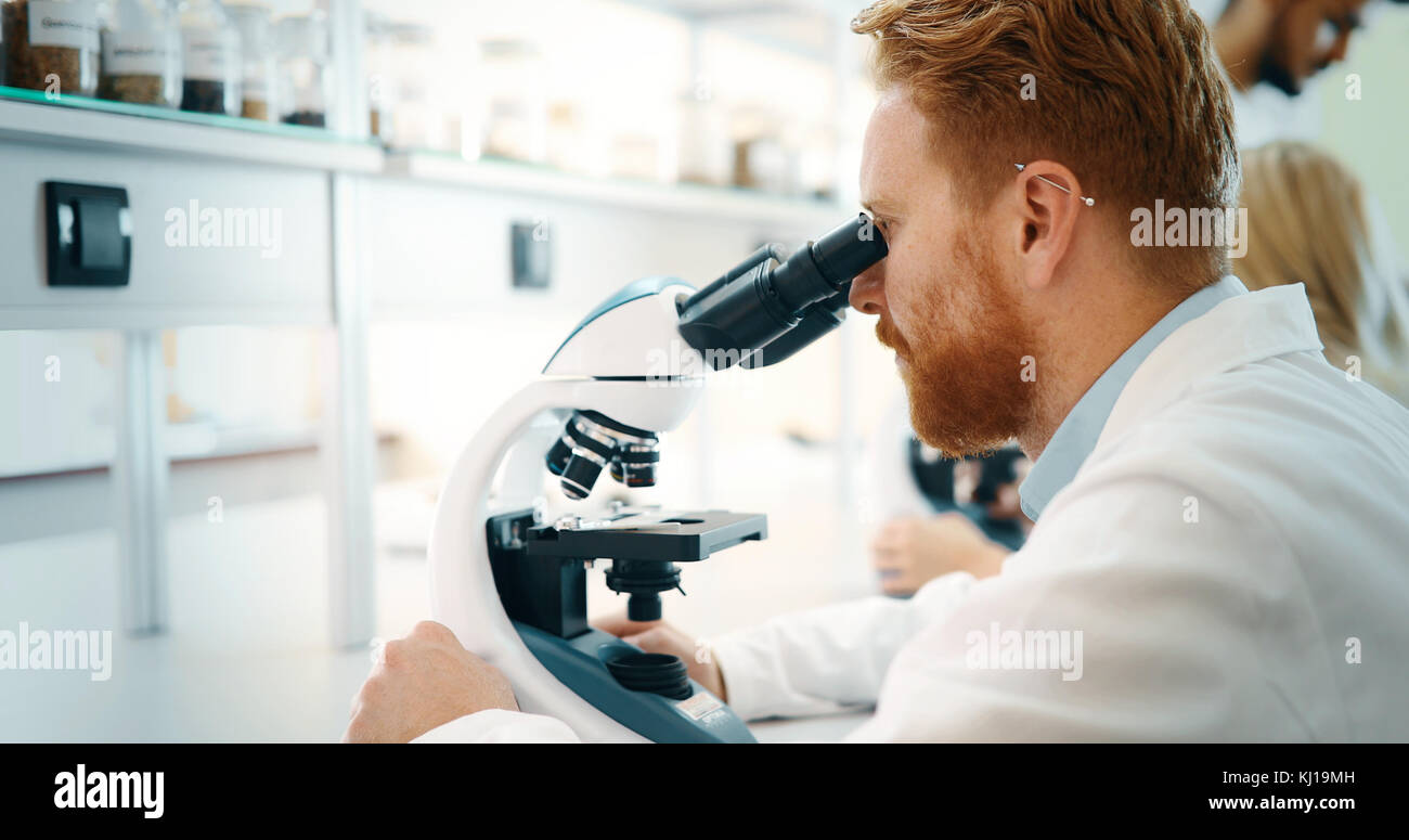 Man looking through microscope hi-res stock photography and images - Alamy