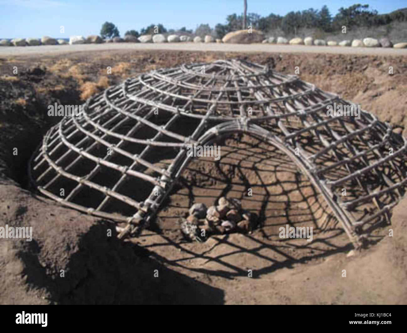 A depiction of Native Americans using the traditional sweat lodge, an ...
