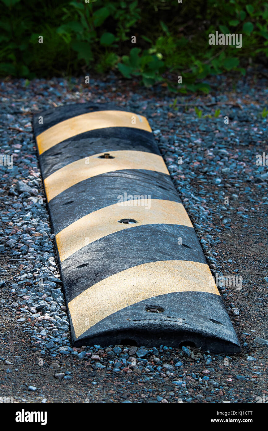 A speed bump on a gravel road Stock Photo - Alamy