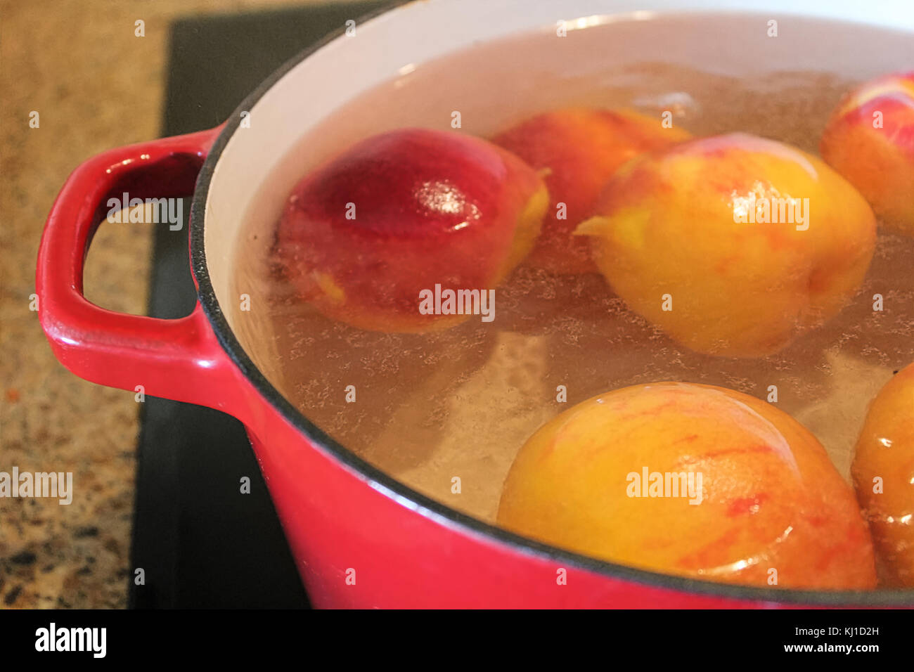 Using boiling water to loosen peach skins Stock Photo - Alamy