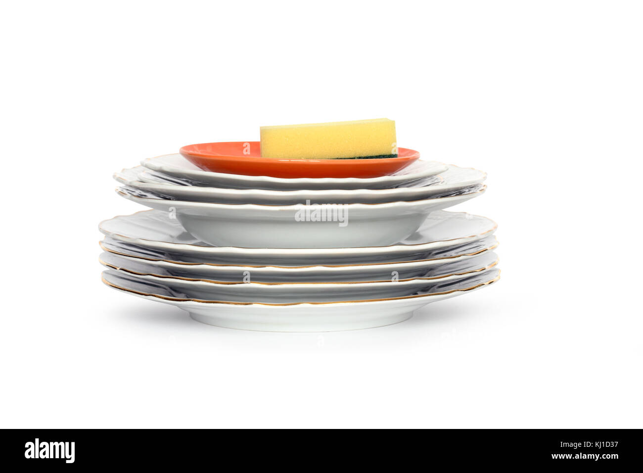 Bath sponge lying on stack of clean plates. Isolated on white with ...