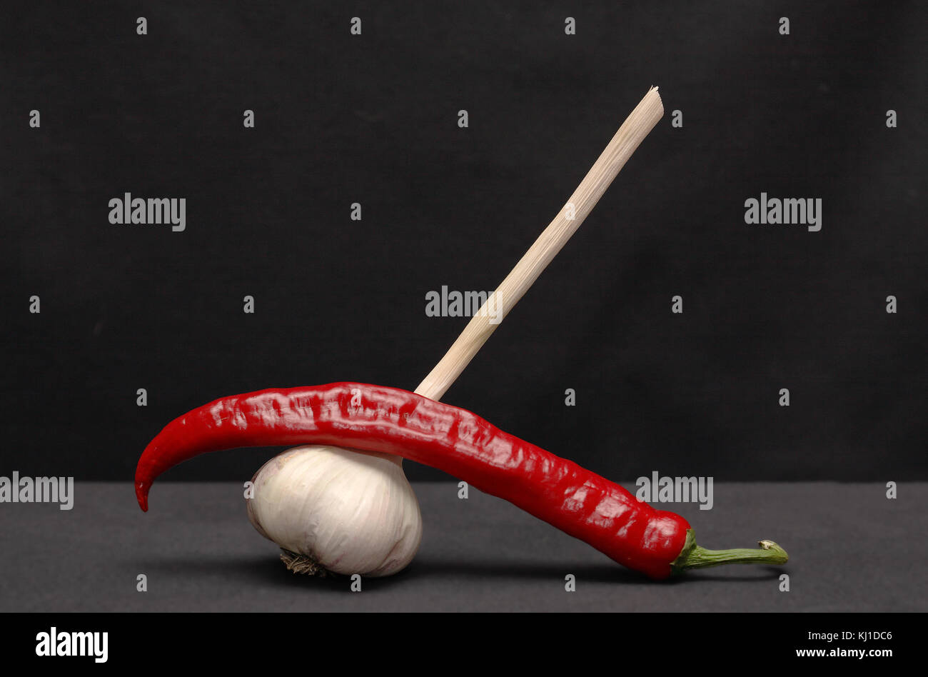 Head of garlic and red chili pepper on dark background Stock Photo - Alamy