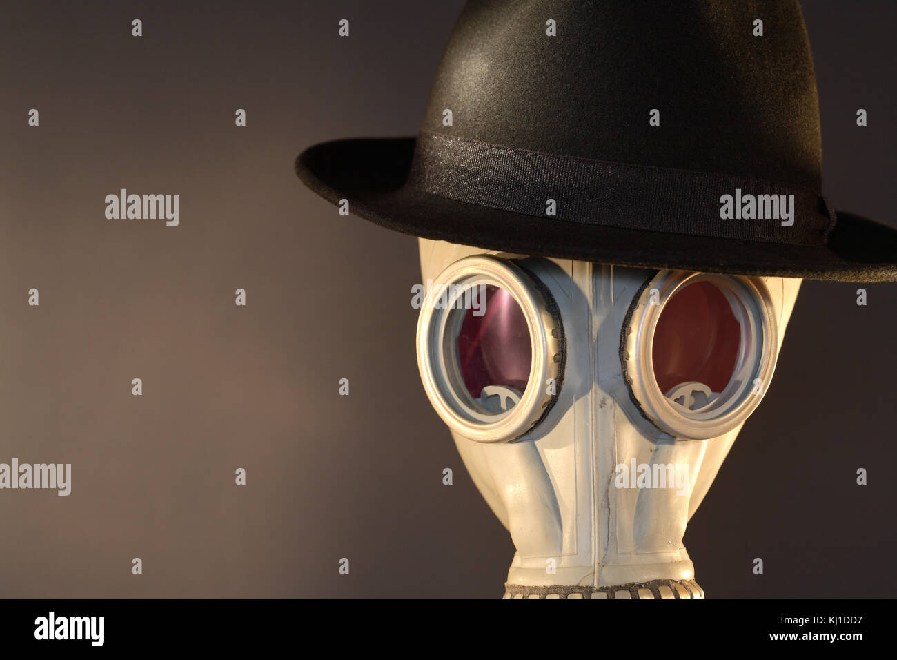 Gas mask with a felt hat closeup on dark background Stock Photo - Alamy