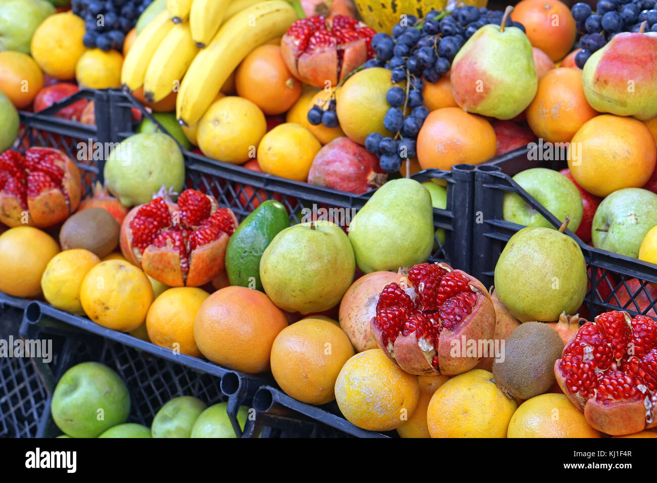 Fresh fruits in plastic baskets at market Stock Photo - Alamy