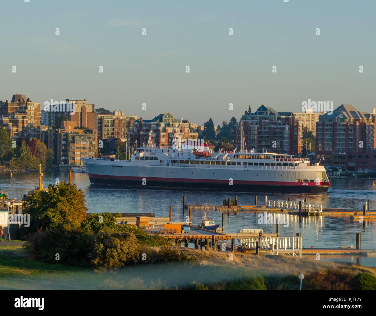 The MV Coho arrives in Victoria Middle Harbour at sunset Stock Photo ...