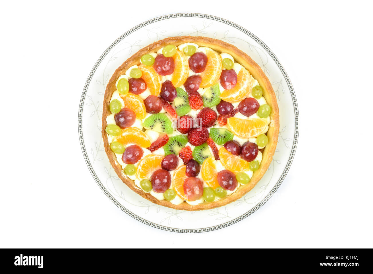 Top view of a fresh homemade multi-fruit tart cake on a plate and ...