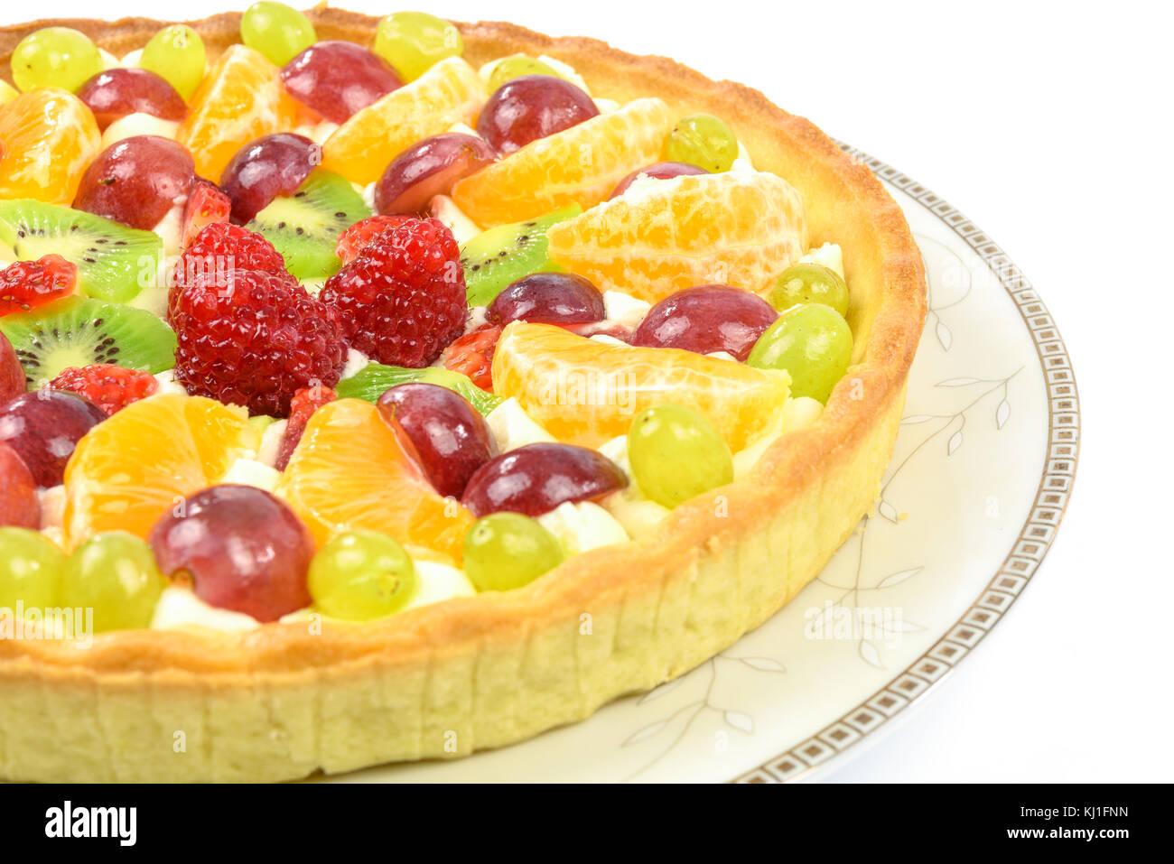 Fresh homemade multi fruit tart cake on a plate and isolated on a white ...