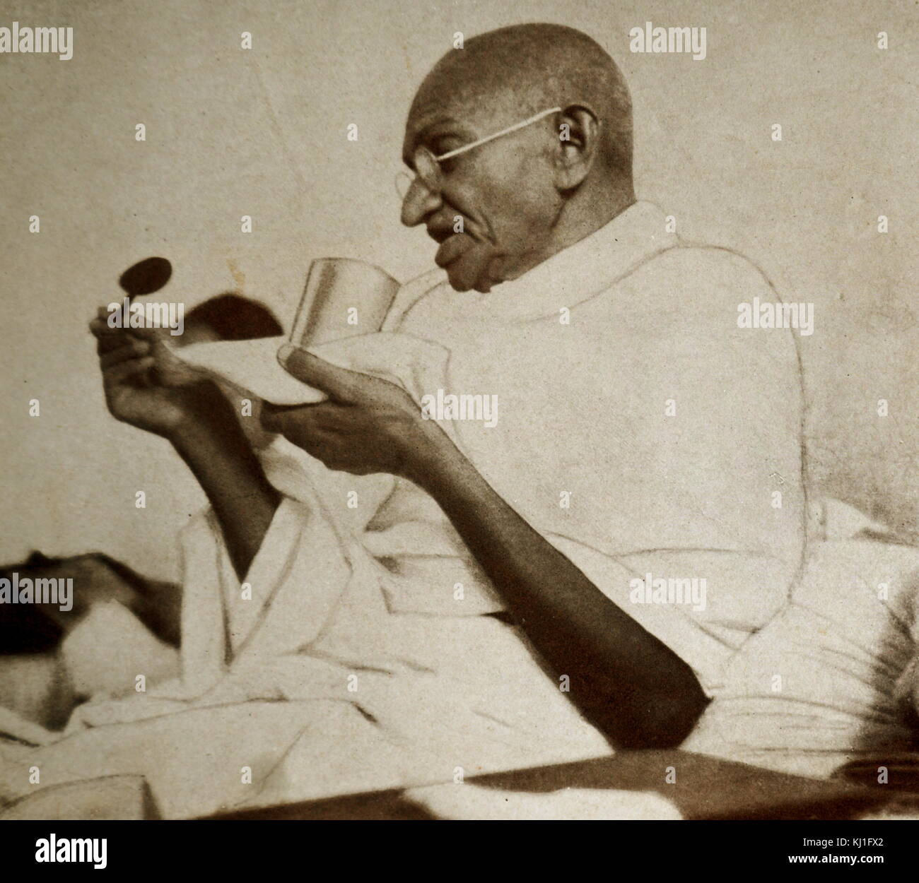Mohandas Karamchand Gandhi (1869 – 1948) takes a meal before a hunger ...