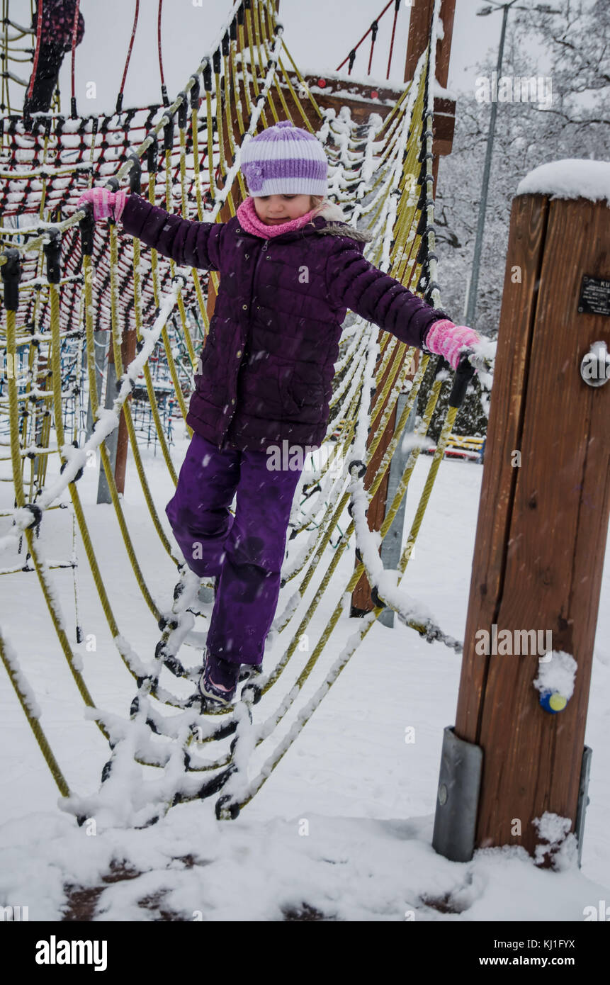 child enjoying playing in winter playground covered by snow Stock Photo ...