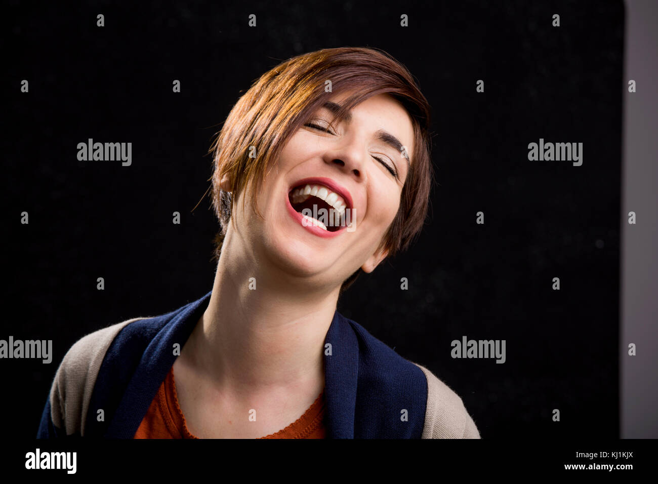 Portrait of a beautiful woman laughing and with a modern hair cut Stock ...