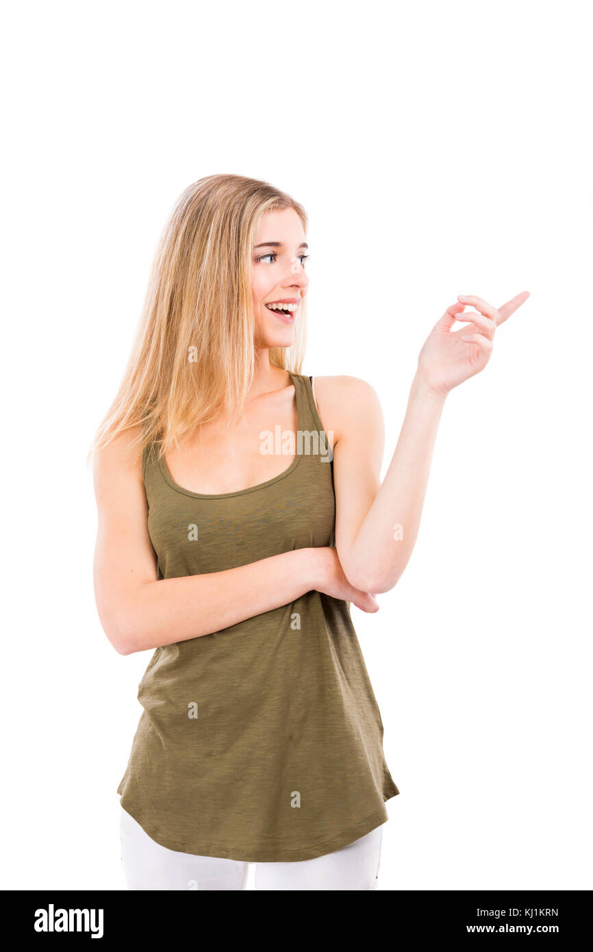 Beautiful blonde woman laughing and pointing to the left, isolated over ...