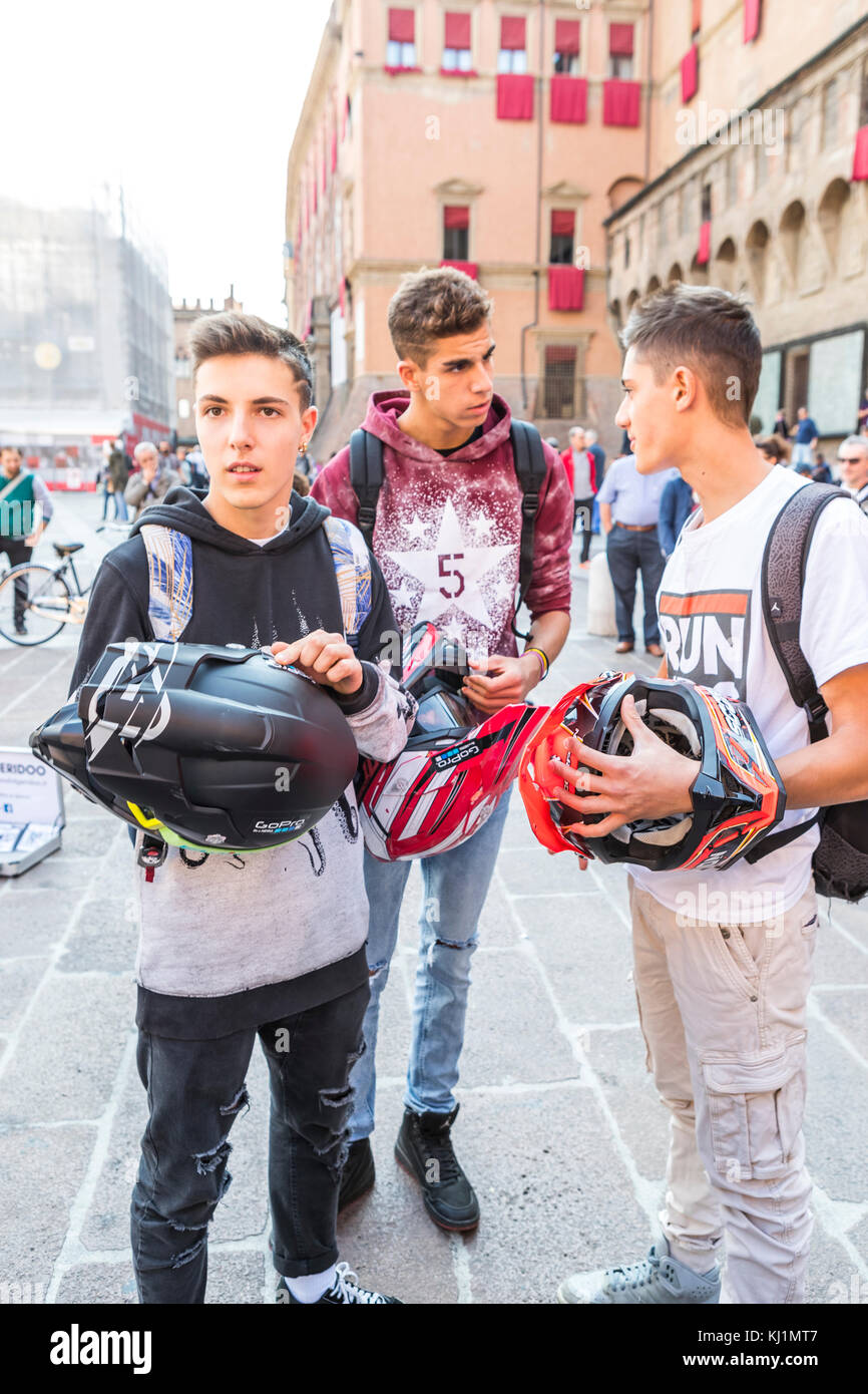 Young Italian men comparing cycle helmets in Piazza del Nettuno ...