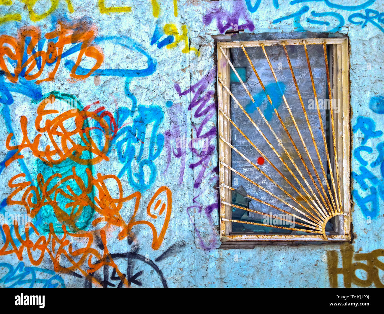 Barred window, wall with graffity Stock Photo - Alamy