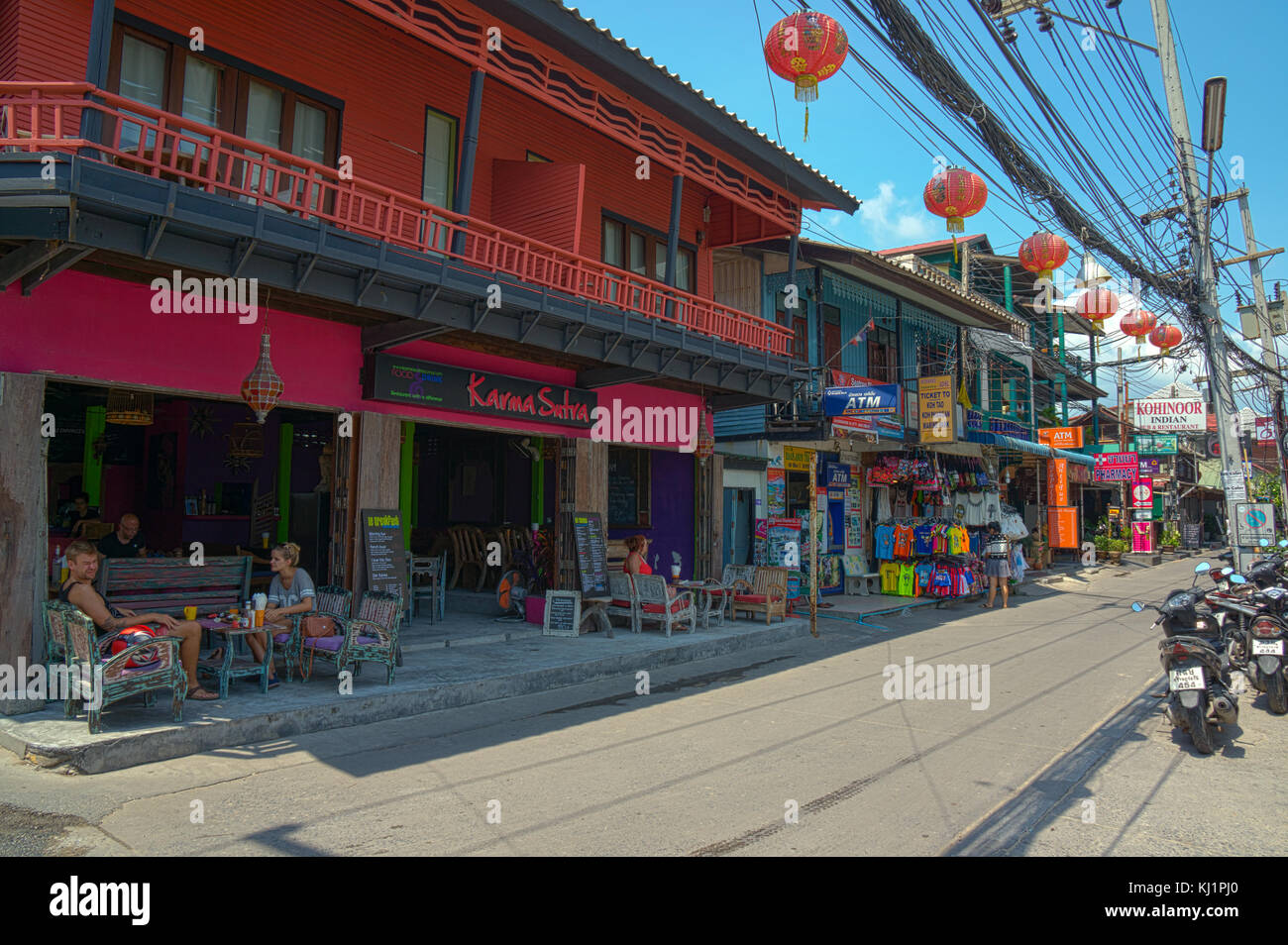 Typical street with many shops and cafes Stock Photo - Alamy