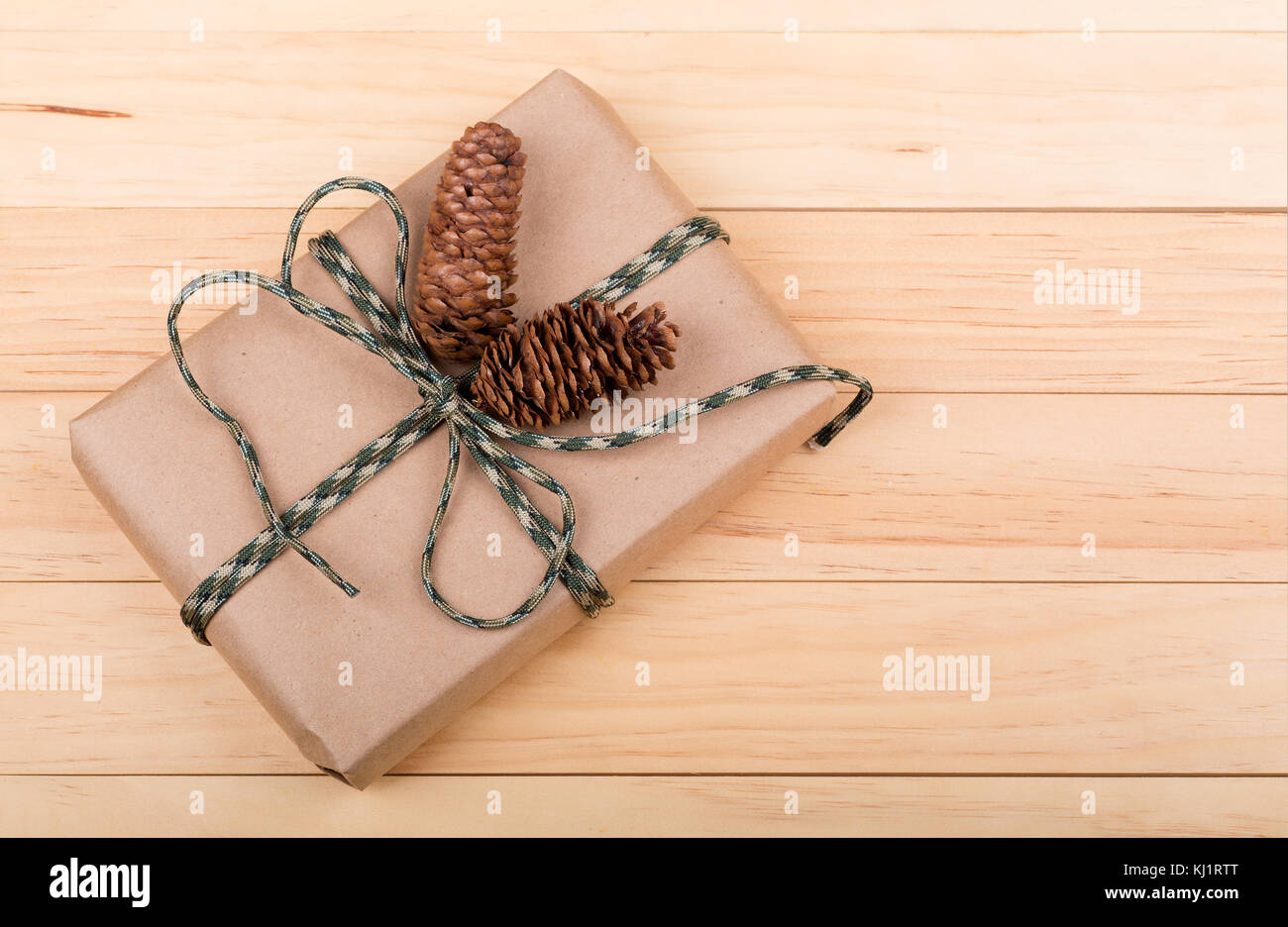Brown package tied with string on wood background Stock Photo - Alamy