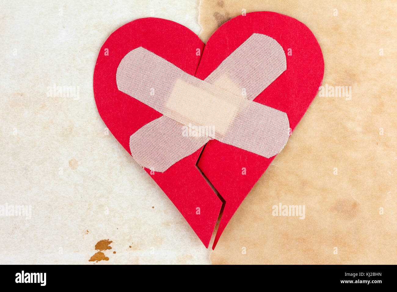 Concept image: A broken heart with bandage Stock Photo - Alamy
