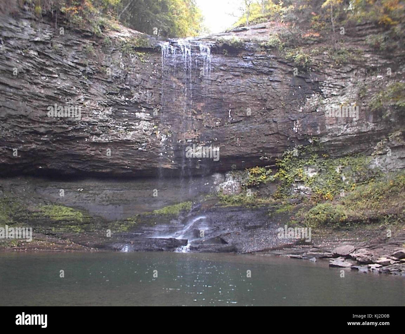 Waterfall over a rocky cliff into a pool of water Stock Photo - Alamy