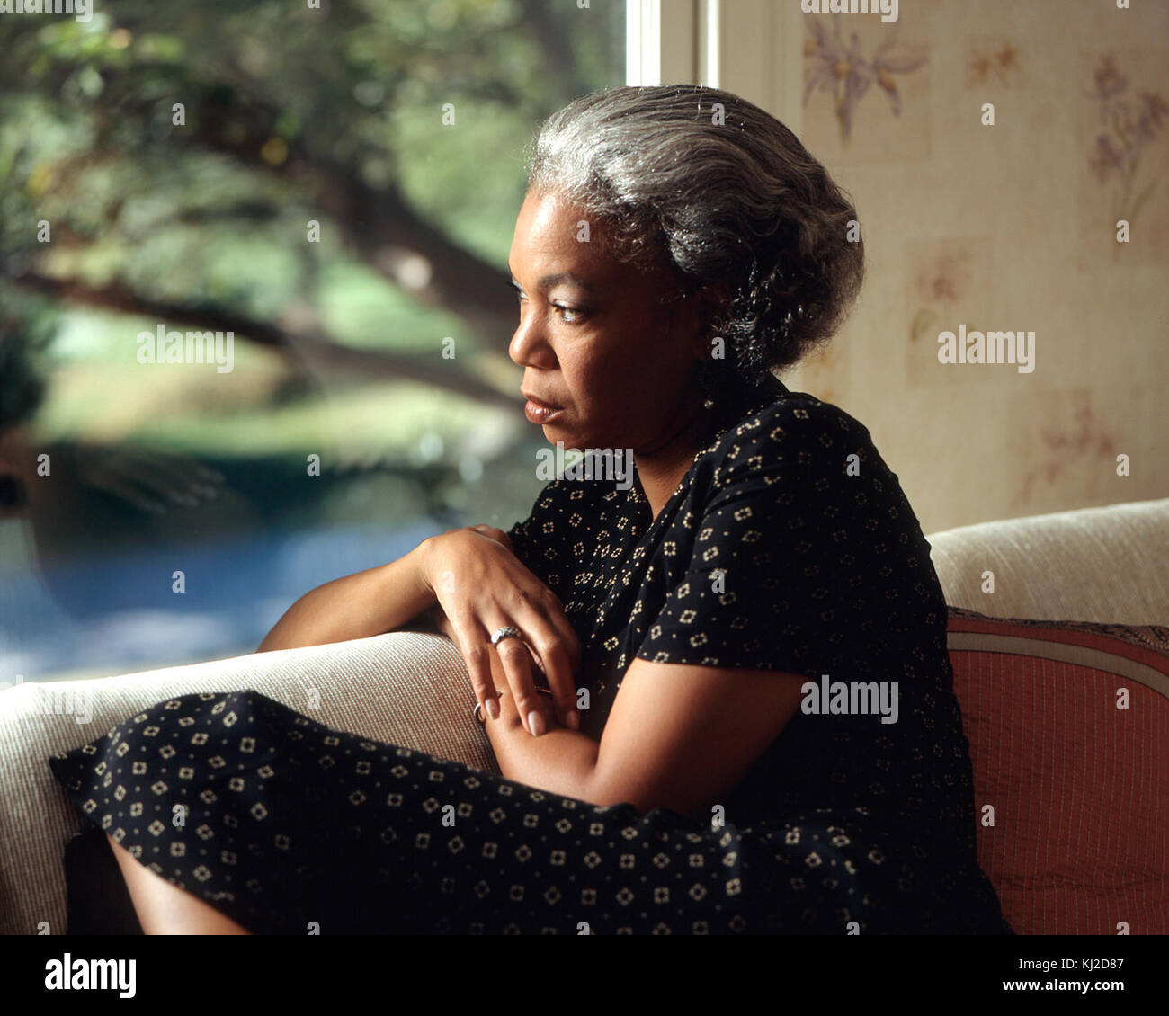 Woman staring out window (1 Stock Photo - Alamy
