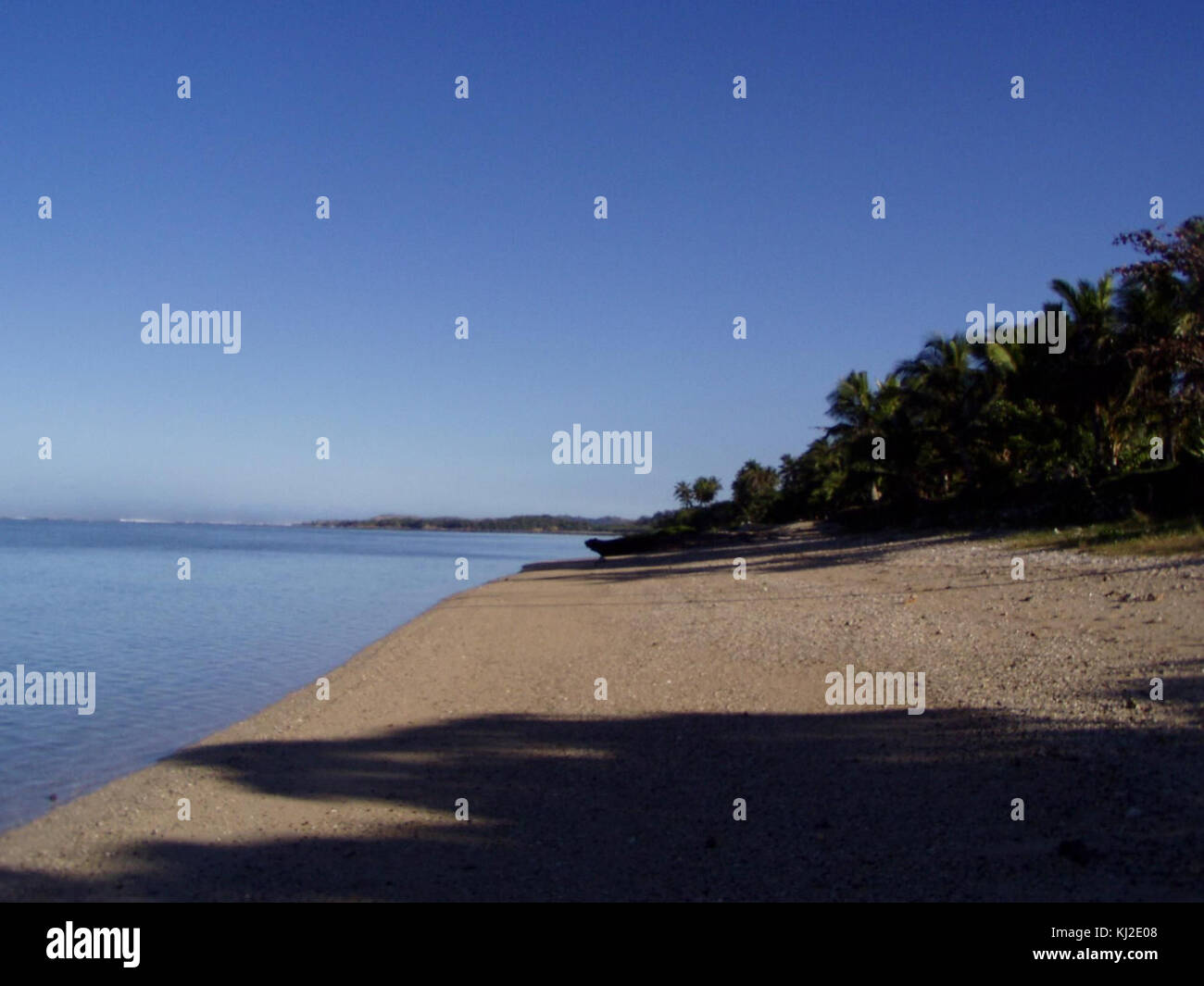 A photograph capturing a beach scene where shadows play a prominent ...