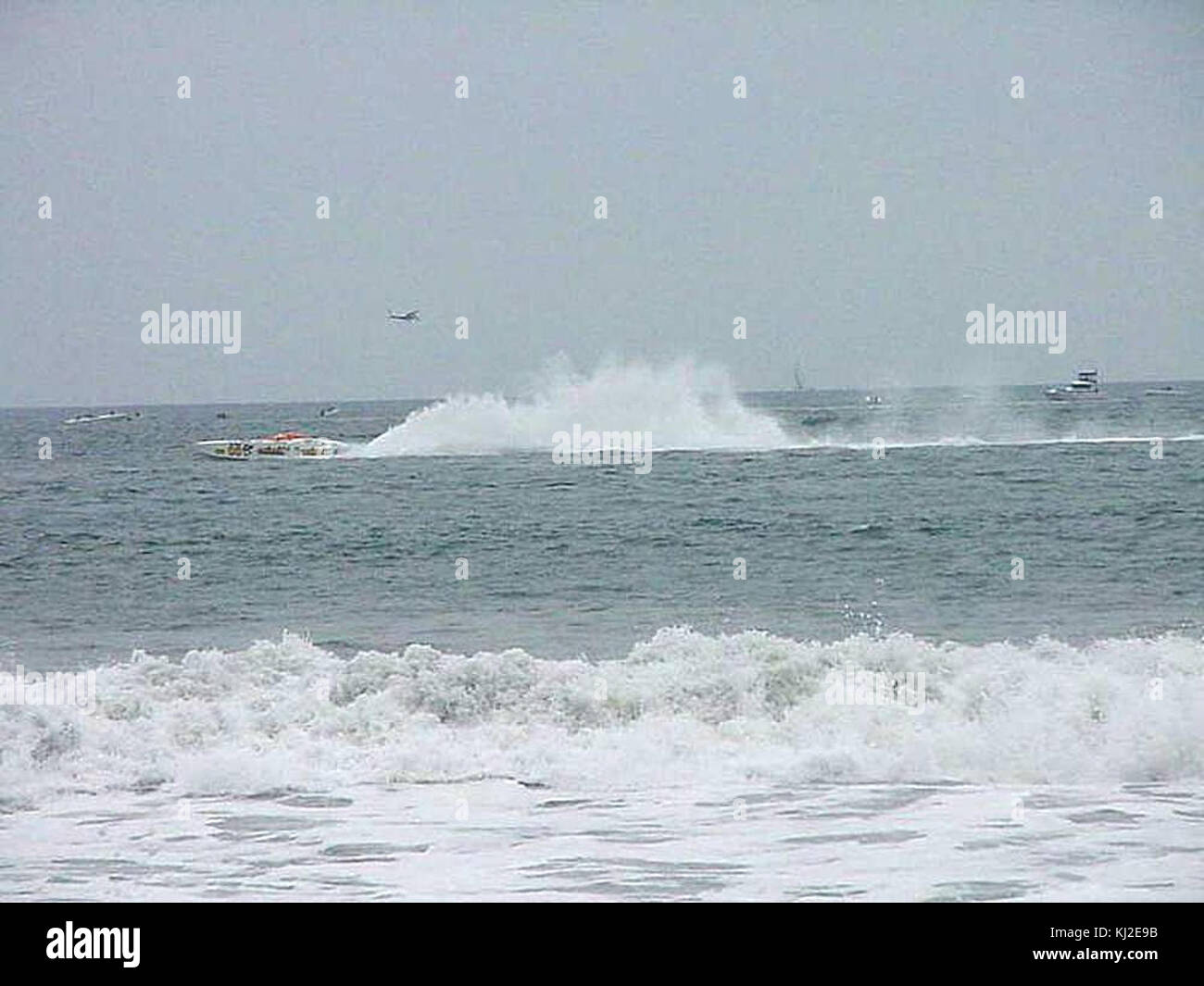 A dynamic scene of boats racing across ocean waves, showcasing the ...