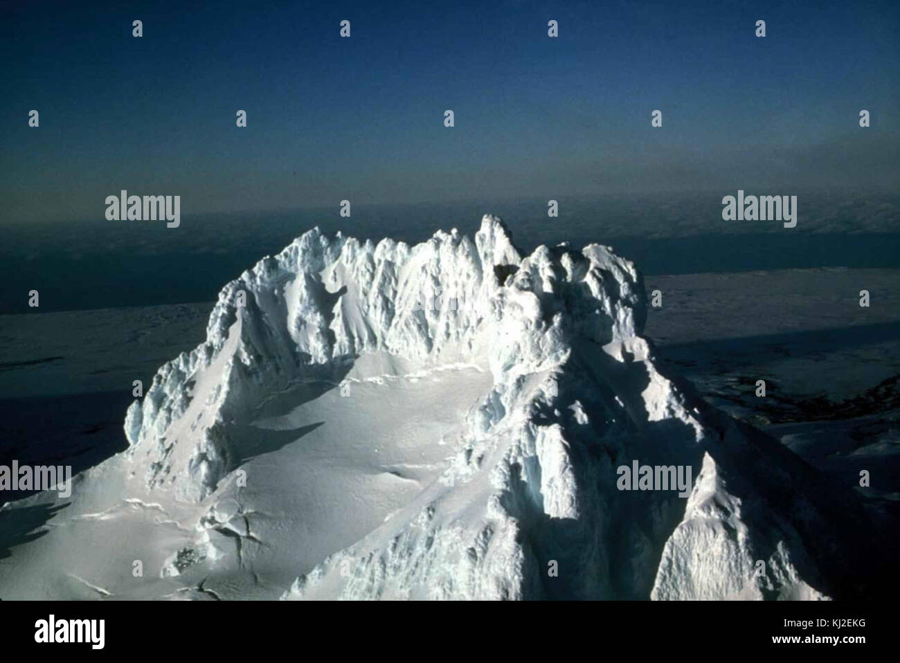 Peaks of volcano under snow Stock Photo - Alamy