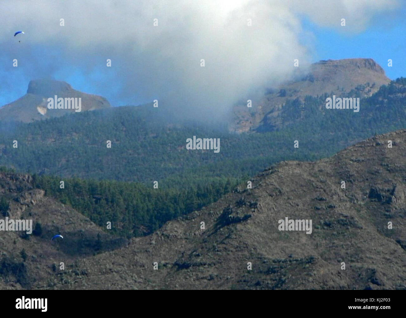 This image captures a natural landscape featuring clouds, mountains ...