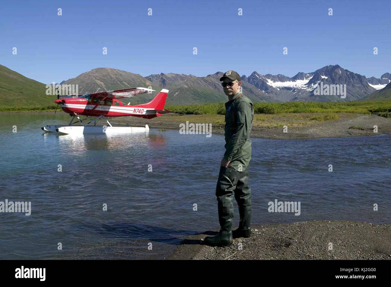 Person on river with small plane in background Stock Photo - Alamy