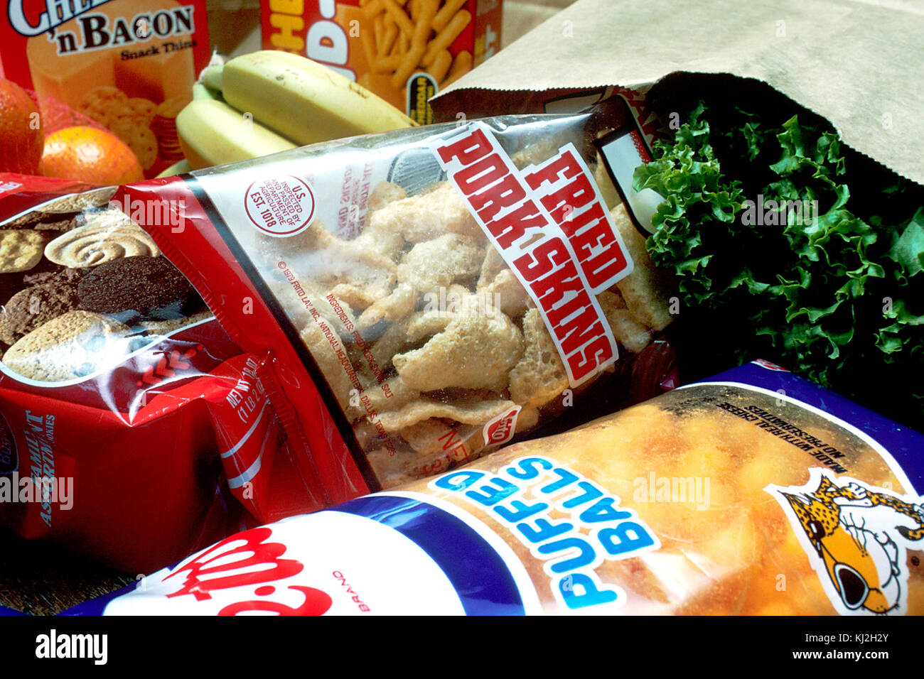 A grocery bag filled with various junk foods, highlighting the popular ...